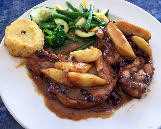 These pork chops aren't just dinner, they're an event—glazed with a sweet-savory sauce and served with vegetables that didn't come from a freezer bag.