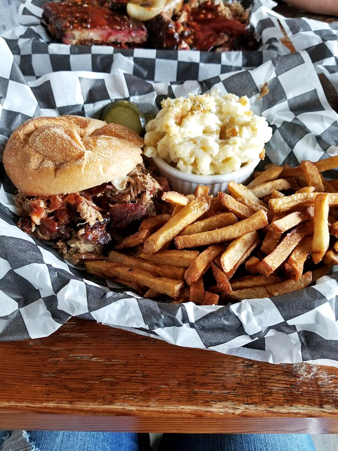 A proper barbecue tray: sandwich spilling with meat, golden fries standing at attention, and mac and cheese that's practically begging for your fork.