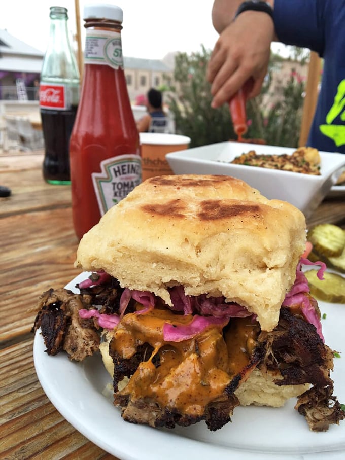 This pulled pork sandwich isn't just food&mdash;it's architecture. The pink slaw provides both structural integrity and tangy contrast to smoky meat.