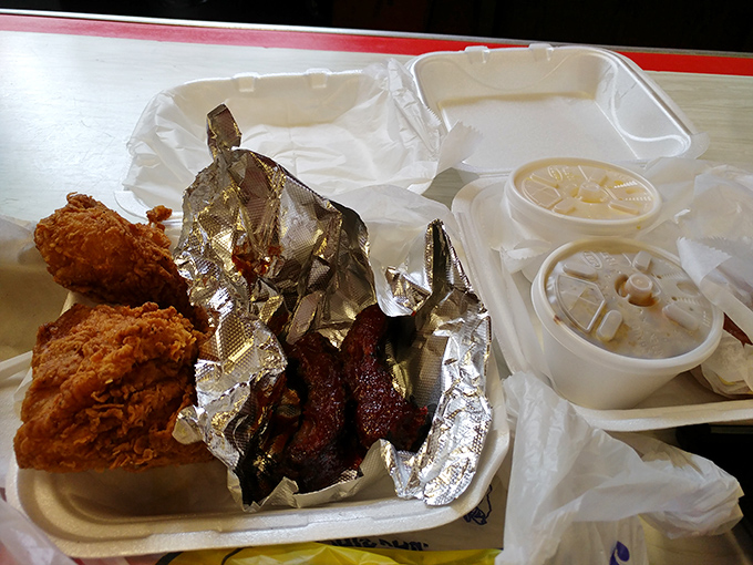 When chicken and ribs share a styrofoam throne. The foil-wrapped ribs are hiding, but they can't escape your hungry gaze.