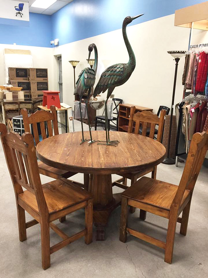 Southwestern dining perfection: a solid wood table flanked by mission-style chairs, with metal herons standing guard over potential dinner conversations. 