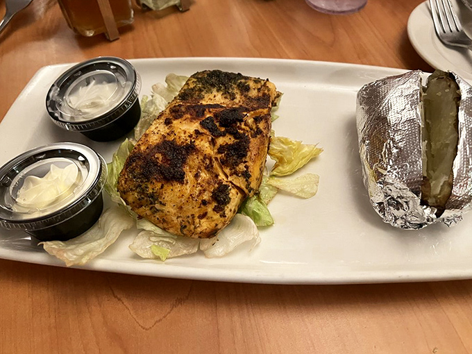 Not in a beefy mood? The blackened salmon resting on crisp lettuce proves Frontier isn't a one-trick pony. That foil-wrapped potato is the silent hero.