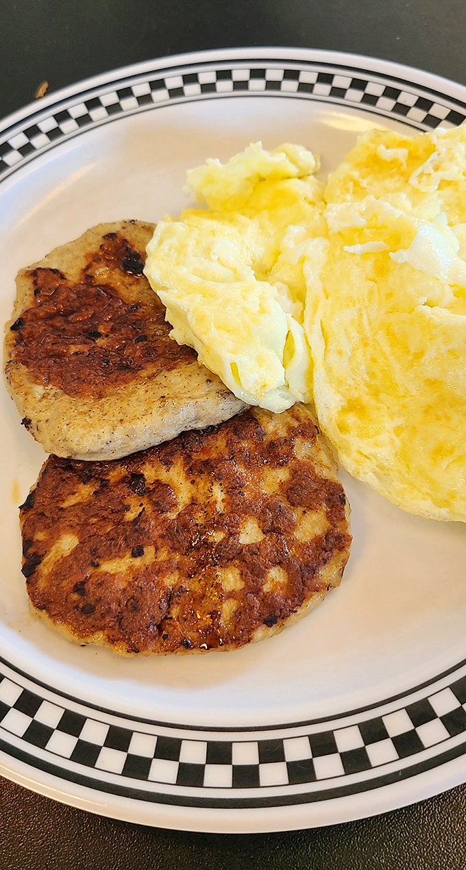 Breakfast fundamentals done right: perfectly browned sausage patties alongside fluffy scrambled eggs. Simple pleasures that remind you why morning meals matter.