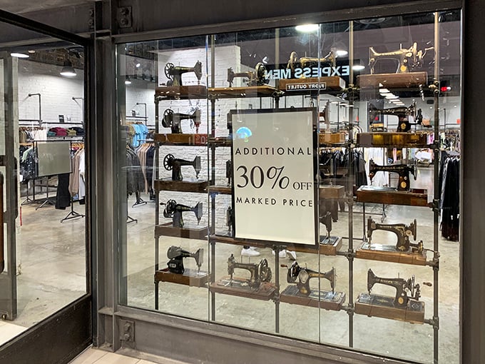 Vintage sewing machines creating window art that screams "we take fashion seriously" while offering serious discounts inside anyway.