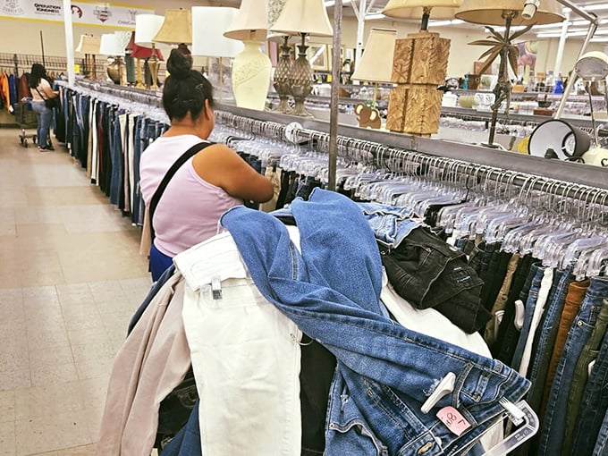 Treasure hunters navigate the clothing racks with practiced precision, each armed with that sixth sense that helps spot designer labels amid the everyday finds.