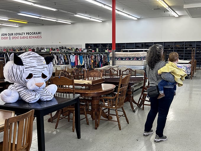 Dining sets and furniture create an impromptu showroom maze where shoppers navigate between someone's past and their own future decor dreams.
