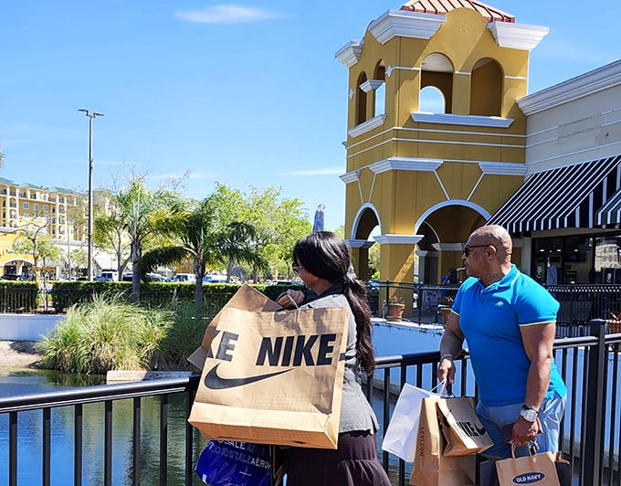 Shopping success measured in branded bags! These savvy shoppers take a moment to enjoy the scenic pond between conquering stores.