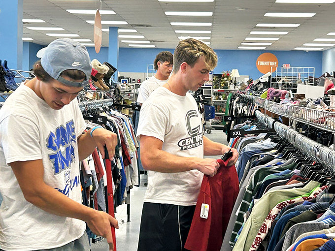 Two shoppers living their best bargain-hunting life, methodically working through racks like seasoned treasure detectives on the case.