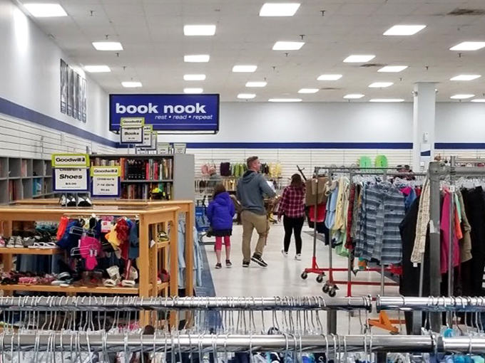 Families navigate the well-organized aisles beneath the "Book Nook" sign, proving that treasure hunting is indeed a multi-generational sport at Virginia Beach's bargain paradise.