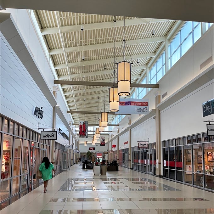 Pristine corridors stretch into the retail horizon, with elegant lighting fixtures guiding shoppers like runway lights for your wallet's final approach.