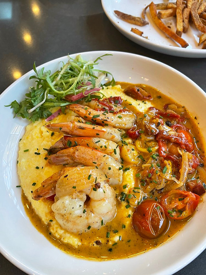 Shrimp and grits: where Southern comfort meets Western altitude. Those plump crustaceans lounging on golden cornmeal are having a better day than you are.