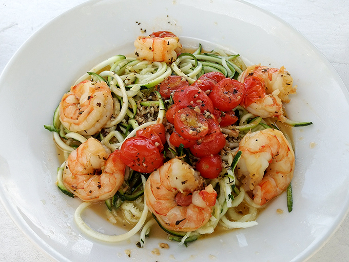 Plump shrimp dance around spiralized zucchini "pasta" with burst tomatoes&mdash;proof that healthy eating and vacation indulgence can coexist beautifully.