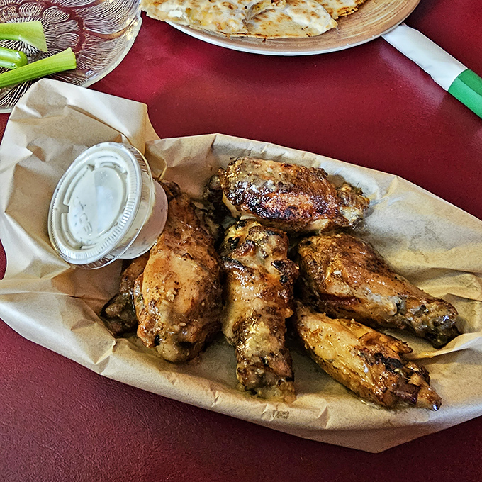 Wings that have clearly been introduced to smoke before meeting heat. Served unpretentiously on paper &ndash; as proper barbecue should be.