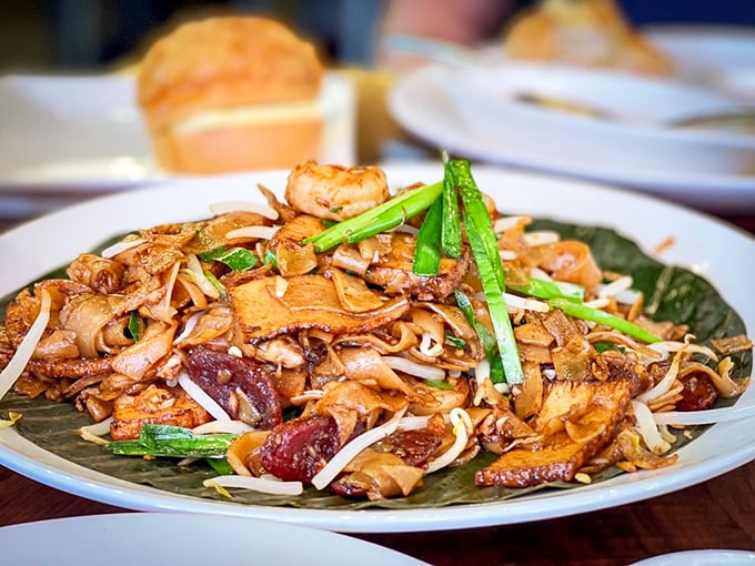 Char kway teow: where flat noodles meet wok magic in a steamy romance that's lasted centuries and still makes hearts flutter at first bite.