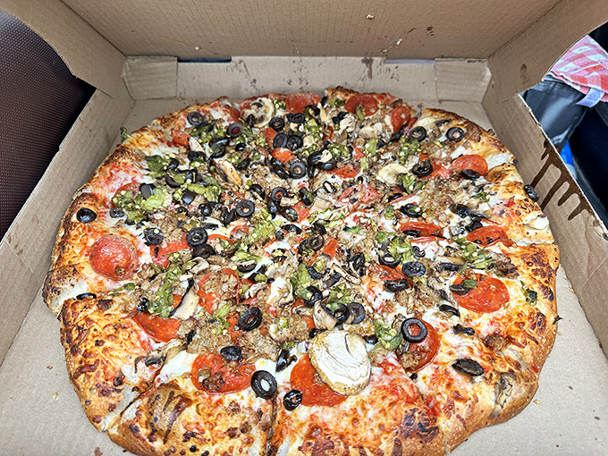 Pizza perfection in a box: where black olives, green peppers, and pepperoni throw the ultimate topping party on a perfectly baked crust.