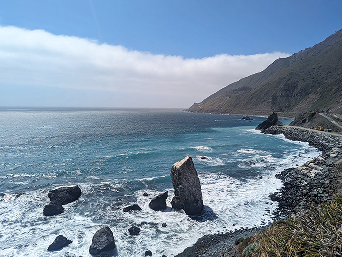 Offshore rocks stand like sentinels guarding Big Sur's pristine coastline. The water clarity here makes the Caribbean look like it's trying too hard.