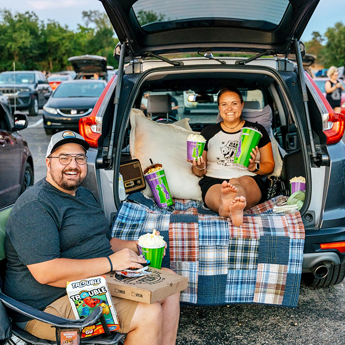 The ultimate tailgate transformed into date night perfection. These moviegoers have mastered the art of drive-in comfort with blankets and snacks aplenty.