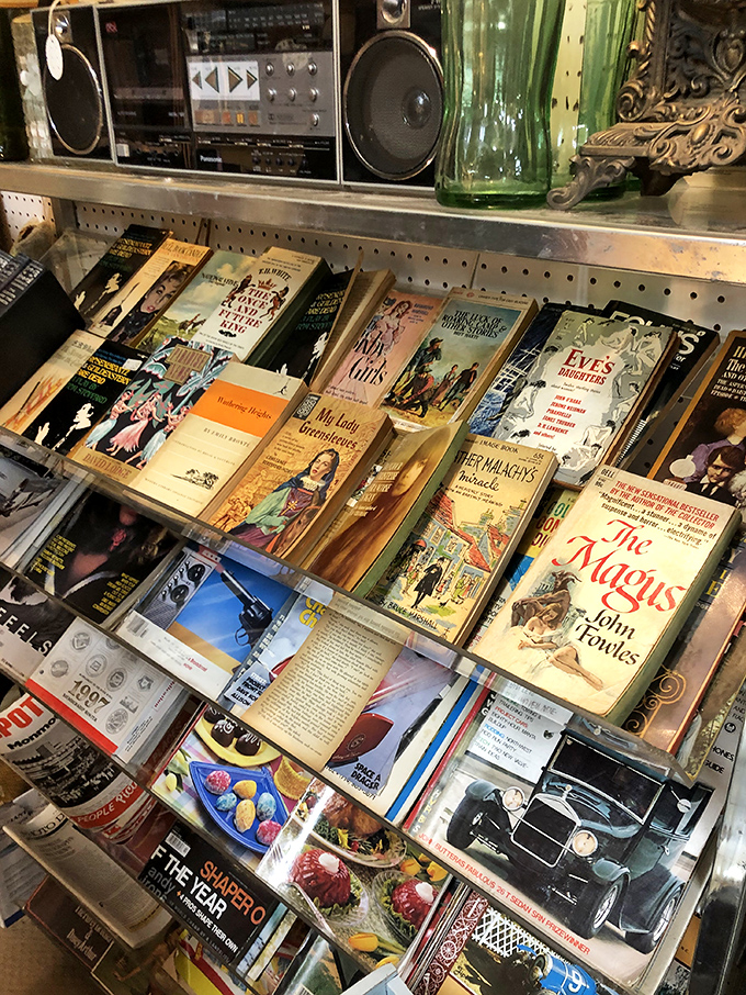 Literary time travel awaits between these covers, where John Fowles' "The Magus" sits mysteriously beside vintage cookbooks and automotive dreams.