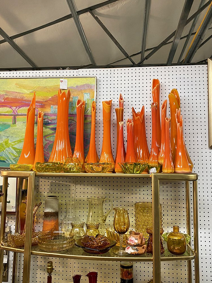 A collection of tangerine-hued glass vases stands tall like a sunset captured in glass. Mid-century modern never looked so fiery!