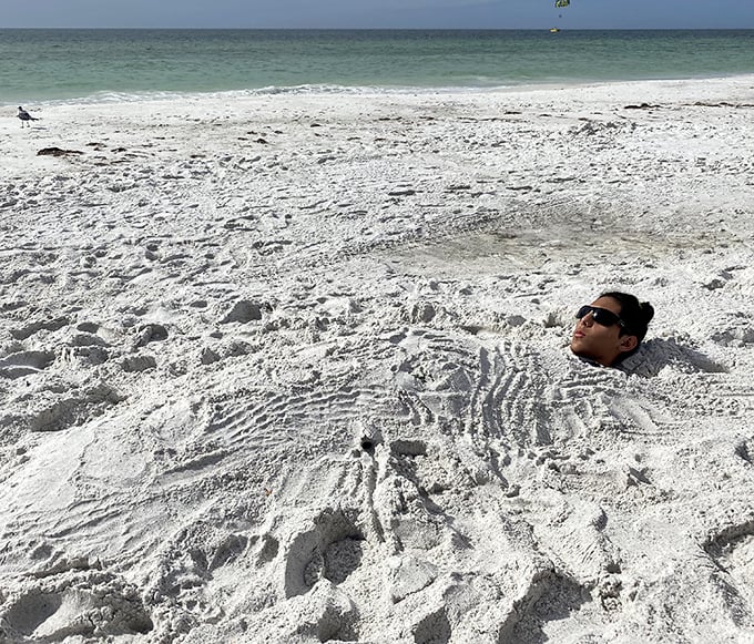The ultimate beach hack: becoming one with the sand. When you're this relaxed, the difference between napping and meditation becomes delightfully academic.