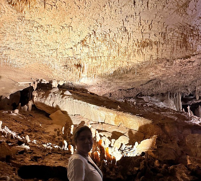 Shadows play across ancient formations in this chamber, where each bump and curve represents thousands of years of slow, persistent creation.