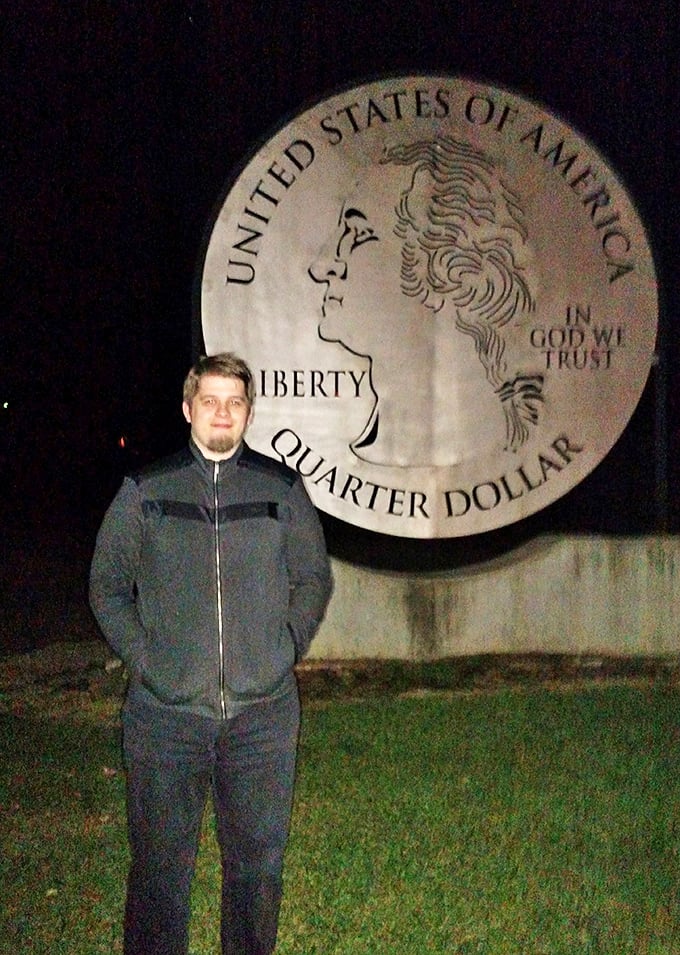 The quarter's metallic surface captures an ethereal glow at night, transforming Washington into a ghostly sentinel watching over travelers.