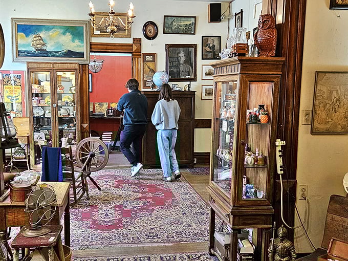 Treasure hunters navigate a room where every wall tells stories&mdash;vintage paintings, ornate furniture, and the thrill of discovery around every corner. 