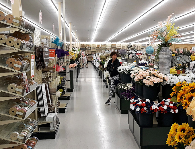 A floral wonderland where artificial blooms never wilt and seasonal decorations await their moment to transform someone's home into a magazine spread.