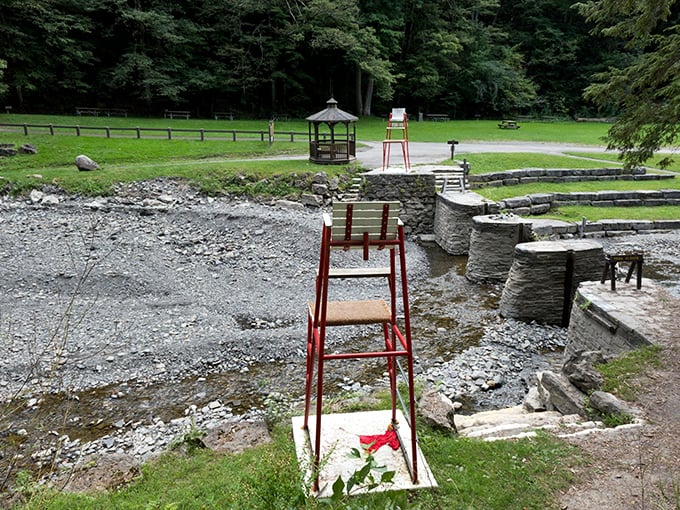 The swimming area awaits summer visitors, complete with vintage lifeguard chairs. Like stepping into a 1950s postcard of the perfect summer day.