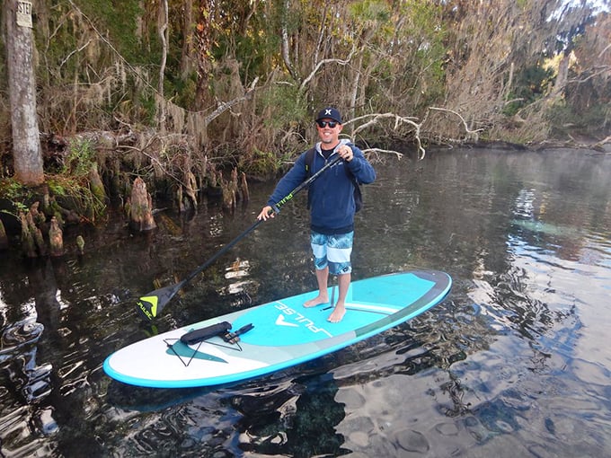 Paddleboarding through crystal waters – like walking on liquid glass while fish photobomb your adventure from below.