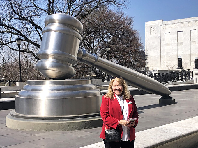 "Your Honor, I'd like to present Exhibit A: proof that Ohio knows how to have fun with serious symbols." A visitor provides scale to this massive monument.