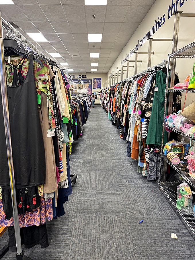 The clothing aisles stretch like runways of possibility. Fashion archaeologists dig through these racks, unearthing designer labels hiding in plain sight.