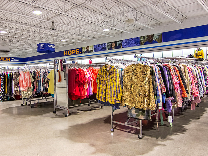 A rainbow of women's clothing stretches beneath inspirational banners, proving that "HOPE" isn't just a word&mdash;it's an entire rack of possibilities.