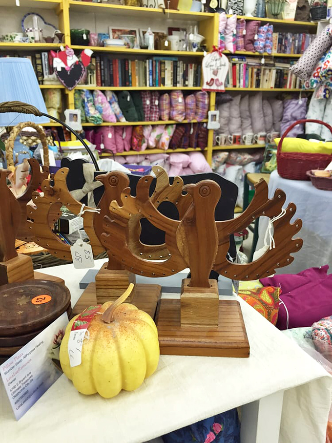 These wooden bird sculptures perch patiently beside a decorative pumpkin, waiting for someone who'll appreciate their rustic charm and craftsmanship.