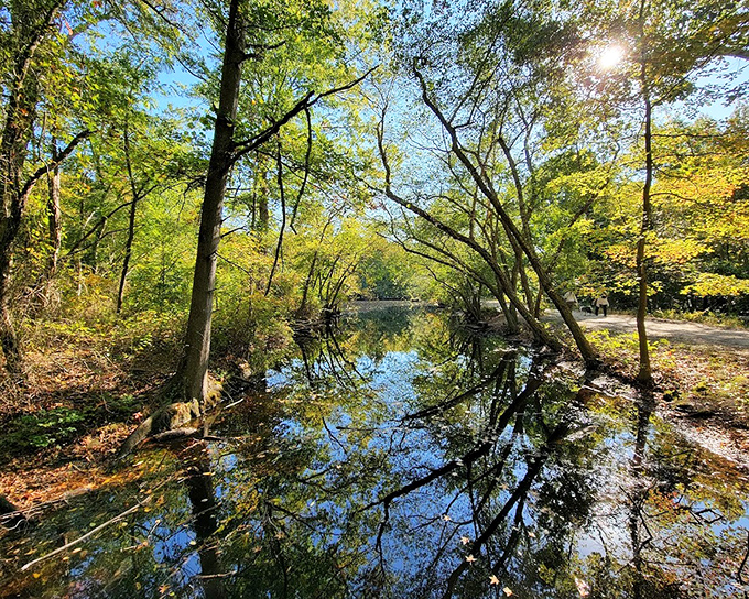 Allaire's riverside path winds through history where iron once flowed and peace now reigns supreme.