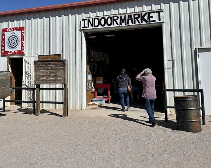 That white unassuming entrance waves hello to bargain hunters like a friendly desert lighthouse guiding shoppers home.