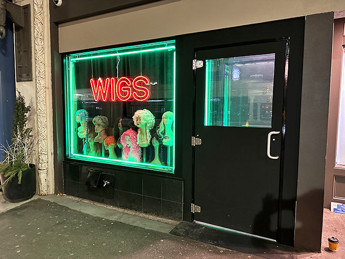 Behind that quirky "WIGS" sign lies a hidden steakhouse sanctuary with deep red walls and white tablecloths.