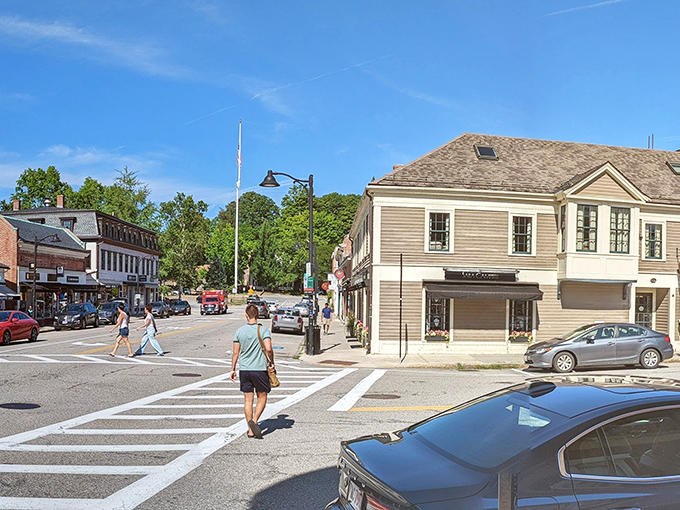 Camden's downtown blends historic charm with modern life, where white buildings and blue awnings invite leisurely afternoon strolls through town.