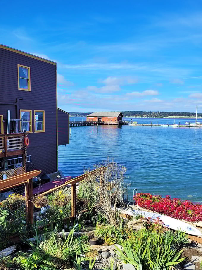 Island living reaches waterfront perfection with bright blooms framing this tranquil harbor scene.