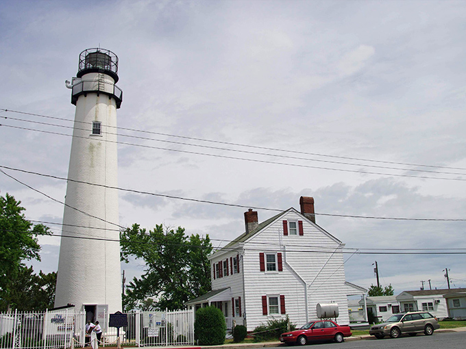 Fenwick Island Lighthouse stands sentinel, a white tower of maritime history against endless blue skies.