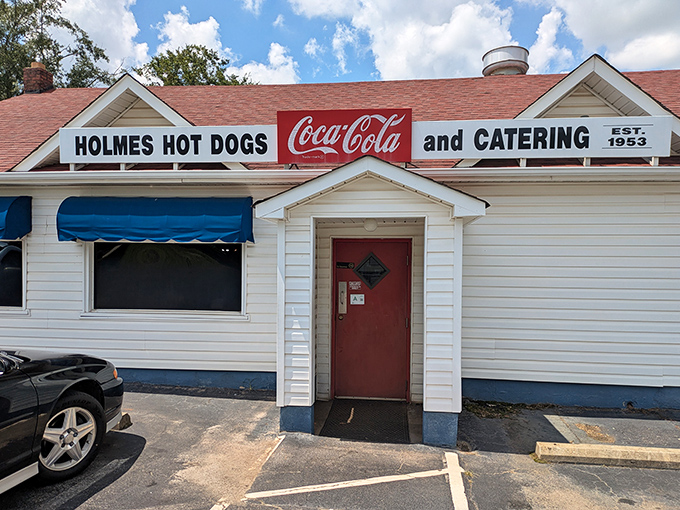Holmes Hot Dogs' classic white building with that iconic red door has been a beacon of deliciousness since Eisenhower was president.