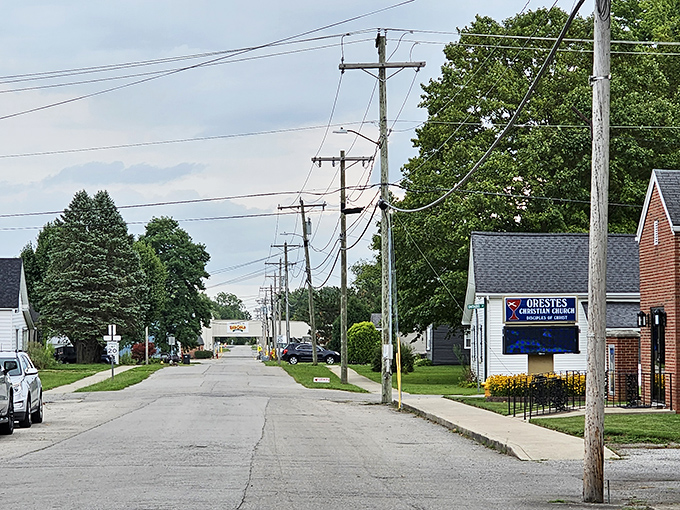 Power line parade! Orestes' main drag showcases small-town living where church announcements and neighborly waves are the social media of choice in this digital detox paradise.