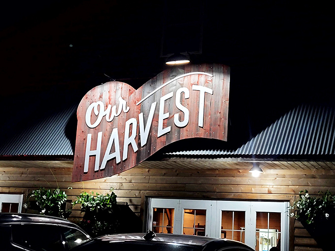 Our Harvest's rustic wooden sign glows with warmth, like the kitchen hearth where farm-fresh ingredients become memorable meals.