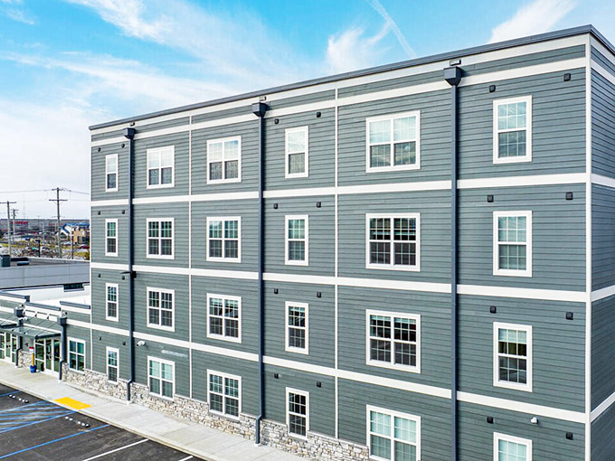 Modern apartments rise against blue skies, proving retirement housing can look sharp without costing a fortune.