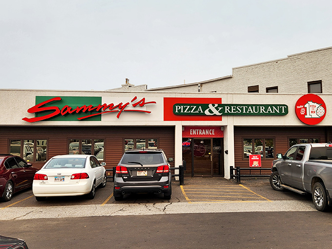 The classic pizzeria sign promises the kind of no-nonsense pizza experience that makes you wonder why you ever bothered with delivery chains.