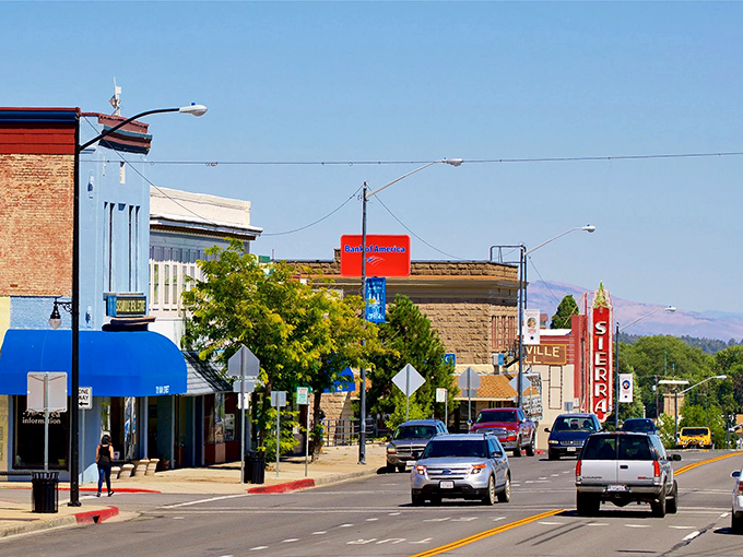 Susanville's Sierra Theatre sign punctuates a street where banking and browsing happen beneath the watchful gaze of distant hills.