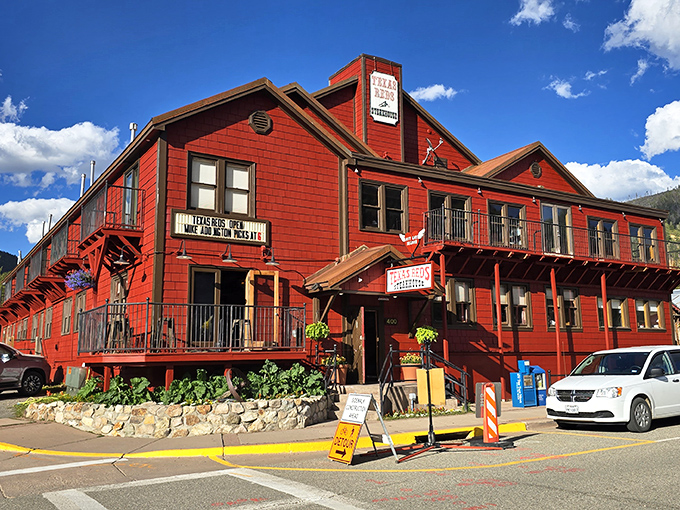 Texas Reds' bold crimson exterior stands out like a juicy steak against the mountain backdrop. This place means business!