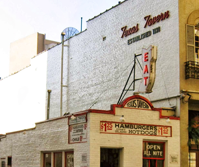 Texas Tavern's neon sign glows like a beacon for hungry souls seeking chili-covered salvation. 