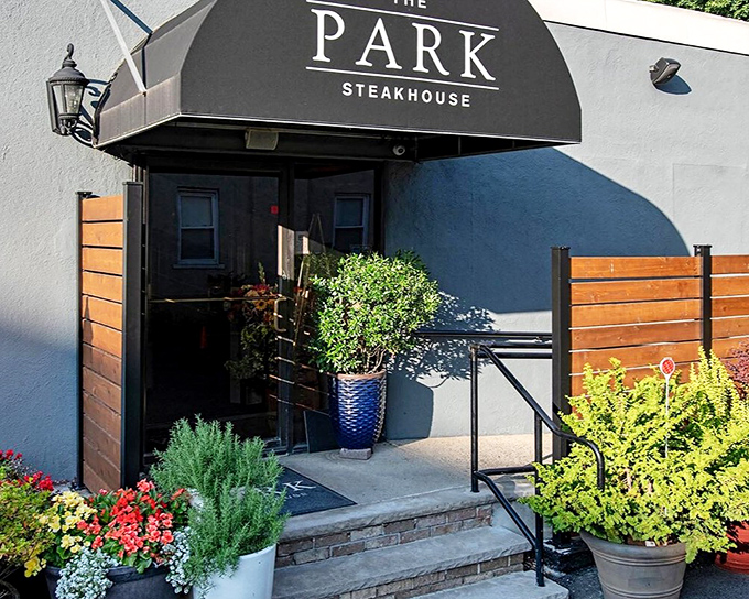 Sleek entrance with garden touches hints at the elevated comfort food experience waiting inside.