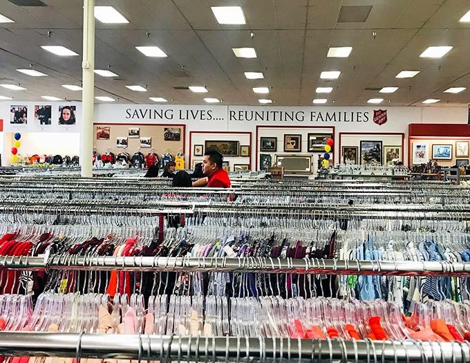 "Saving Lives... Reuniting Families" - The Salvation Army's mission hangs above a sea of colorful clothing possibilities.